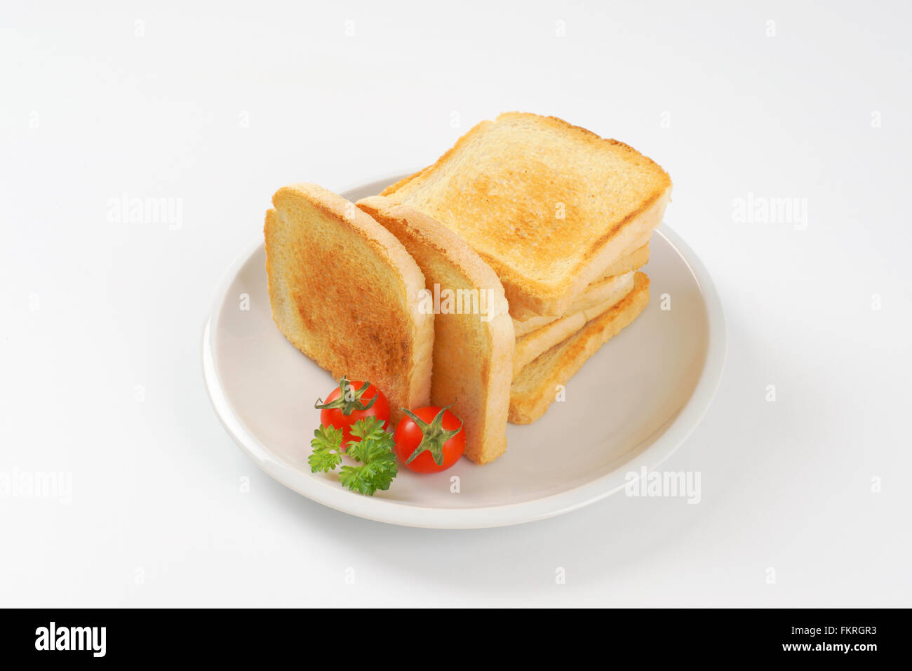 plate of freshly made toasts on white background Stock Photo - Alamy