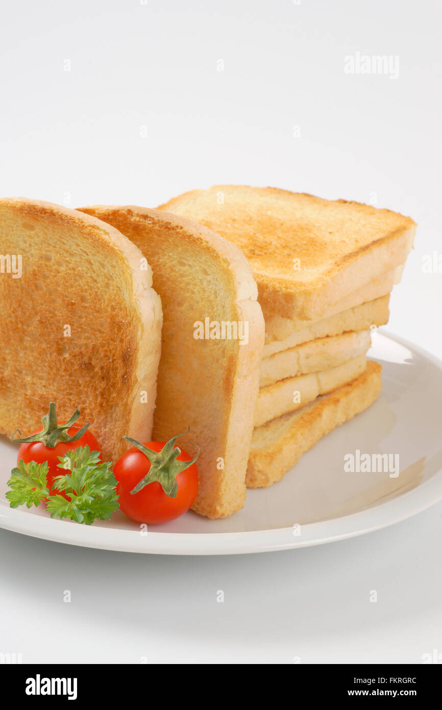 plate of freshly made toasts on white background Stock Photo - Alamy