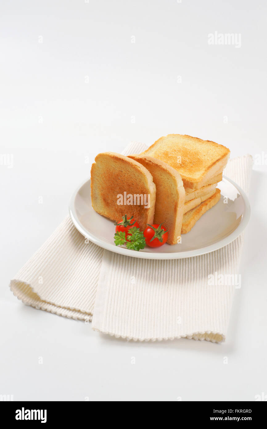 plate of freshly made toasts on white place mat Stock Photo - Alamy