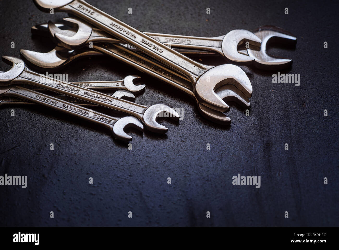 Set of the stainless steel wrench on dark background with space for ...