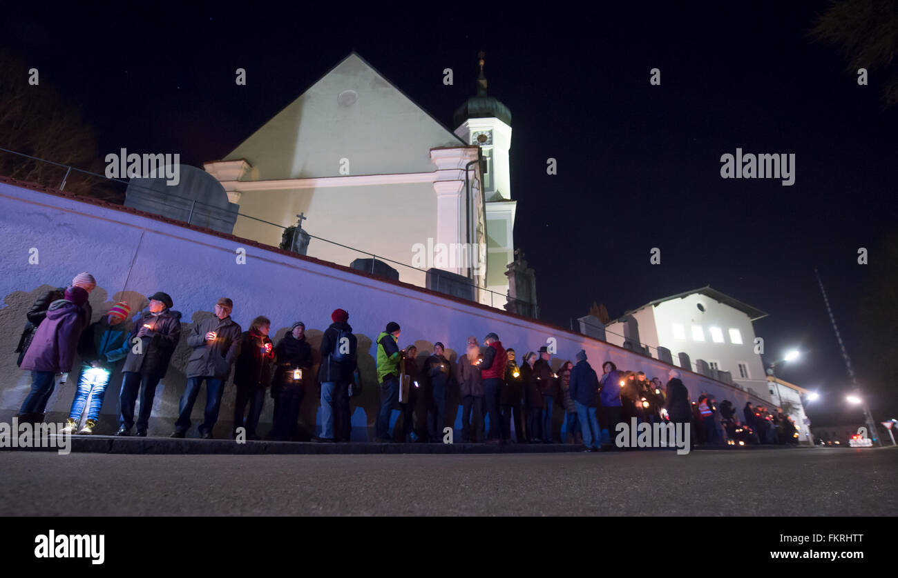 Zorneding, Germany. 09th Mar, 2016. People form a chain of lights along ...