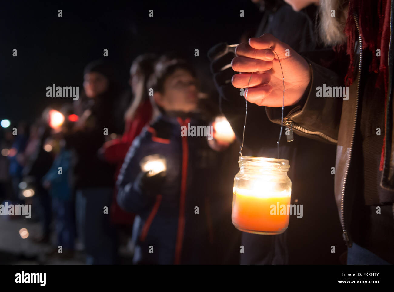 Zorneding, Germany. 09th Mar, 2016. People form a chain of lights along ...