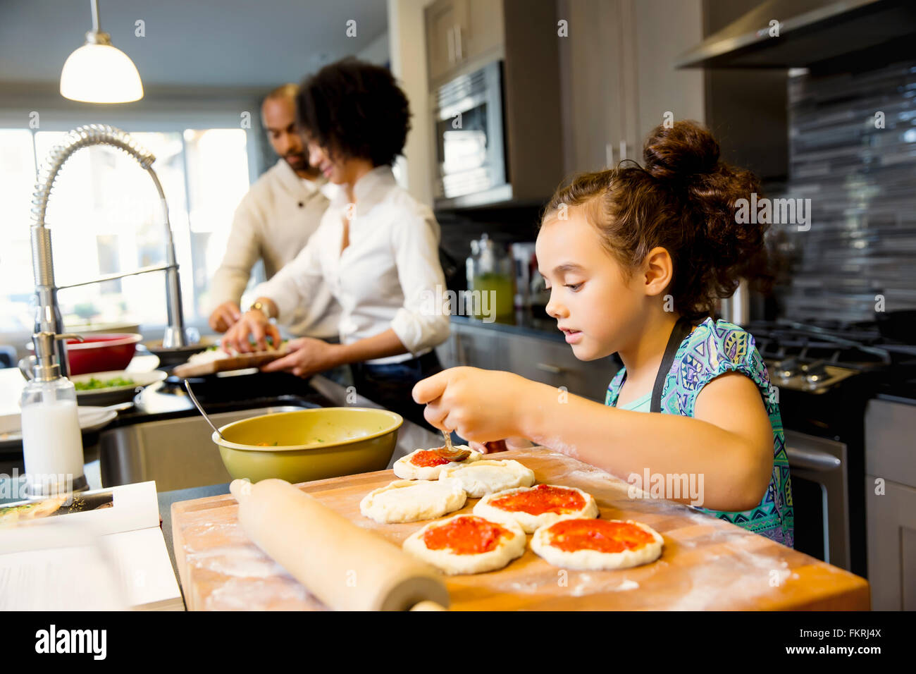 Family cooking in kitchen Stock Photo - Alamy