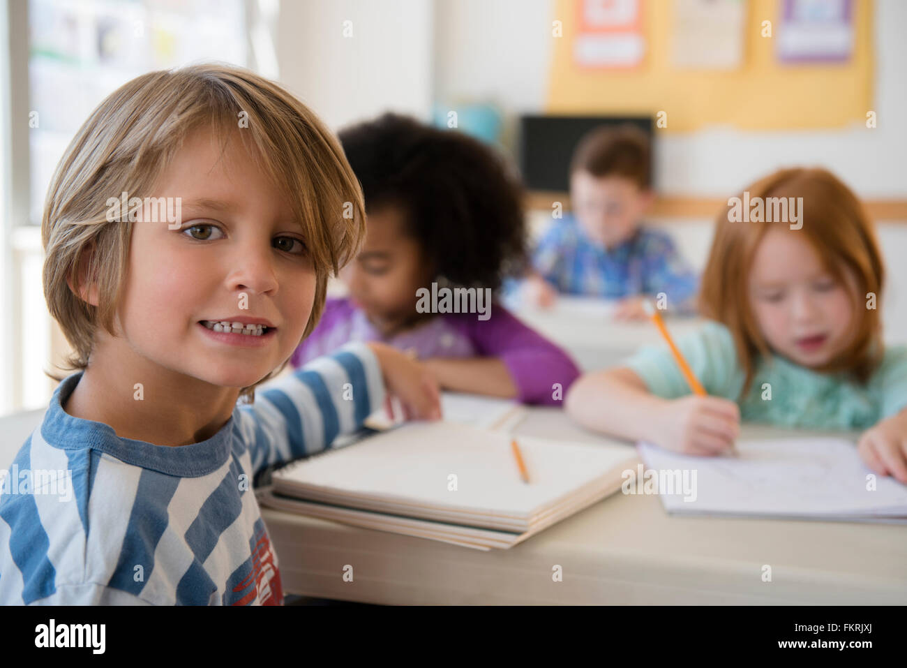 Student smiling in classroom Stock Photo - Alamy