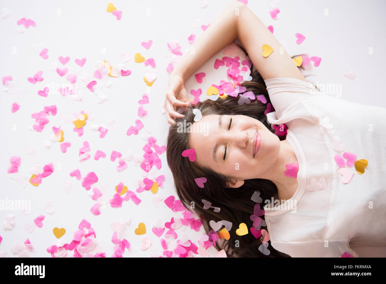 Young woman celebrating in confetti hi-res stock photography and images - Alamy