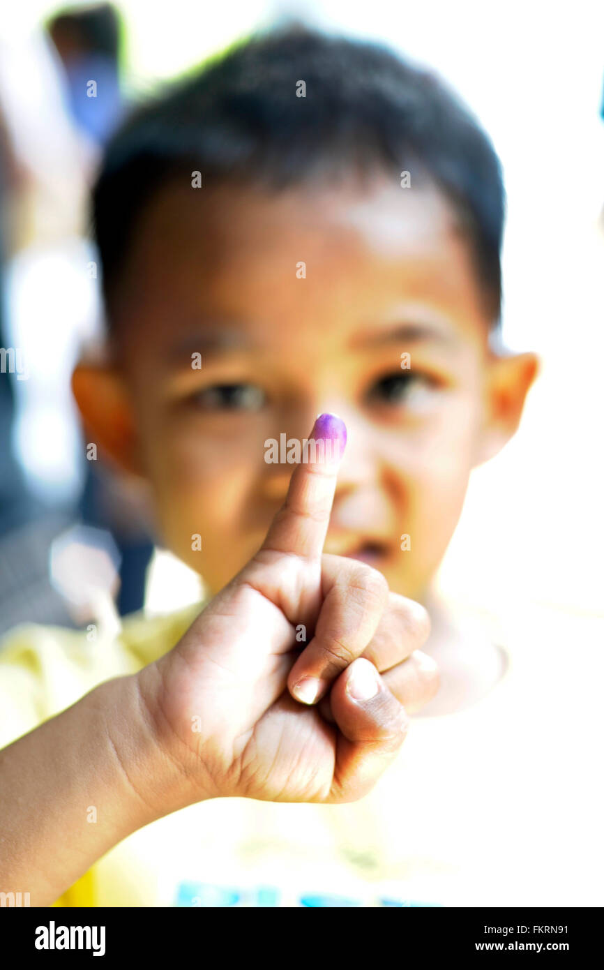 A boy showing his hand that has been marked with ink after receiving ...
