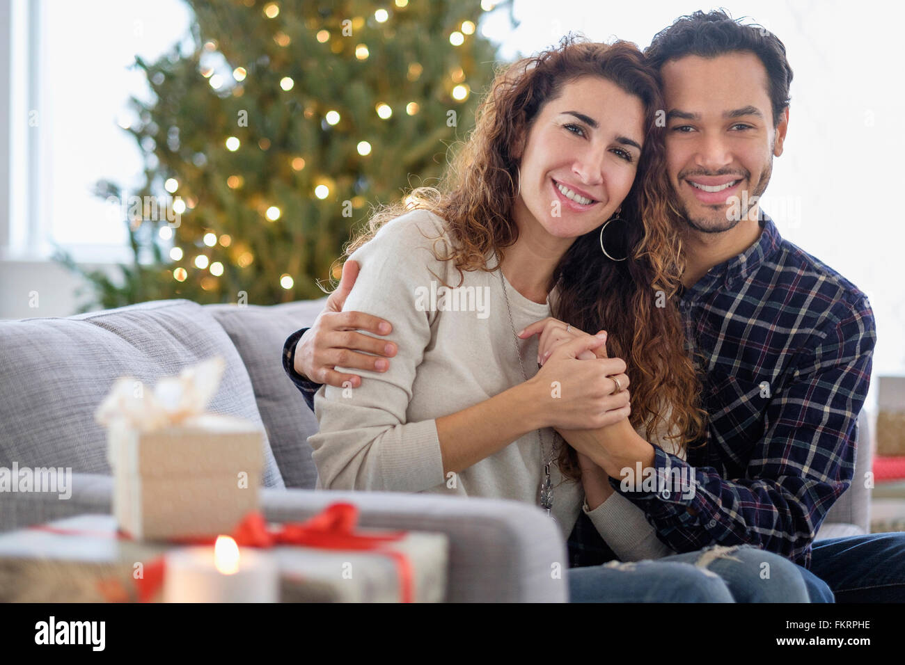 Couple hugging on sofa hi-res stock photography and images - Alamy