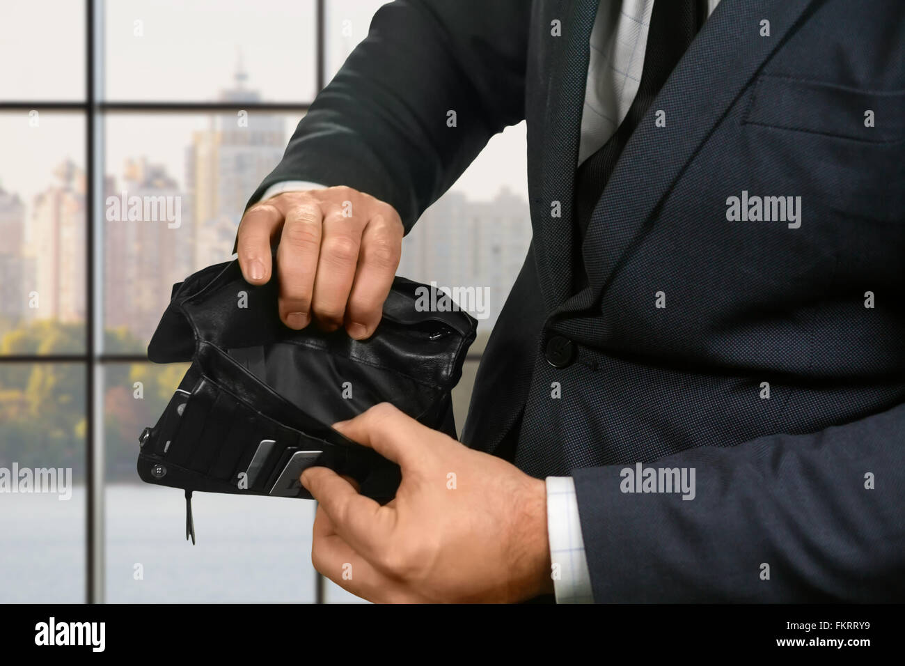 Official holding an empty wallet Stock Photo - Alamy
