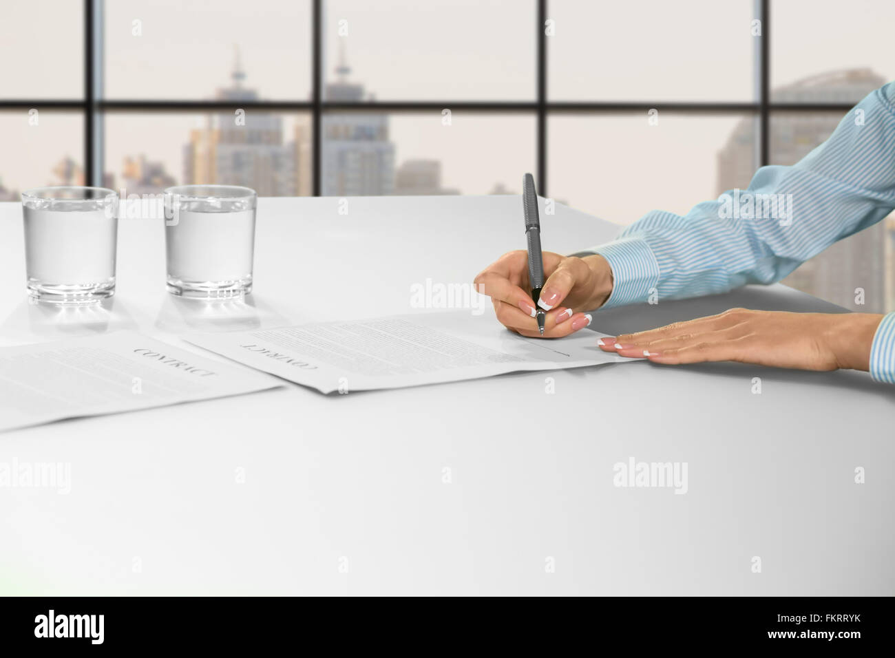 Female office employee signing papers Stock Photo - Alamy