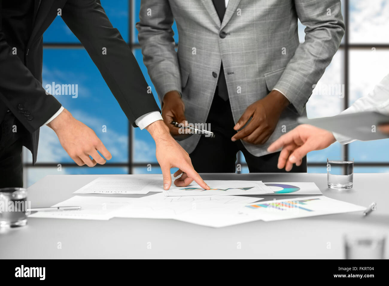 Business people working beside window Stock Photo - Alamy