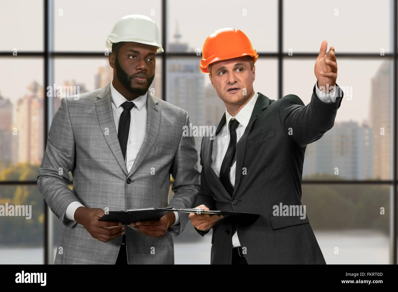 Two construction managers' daytime conversation Stock Photo - Alamy