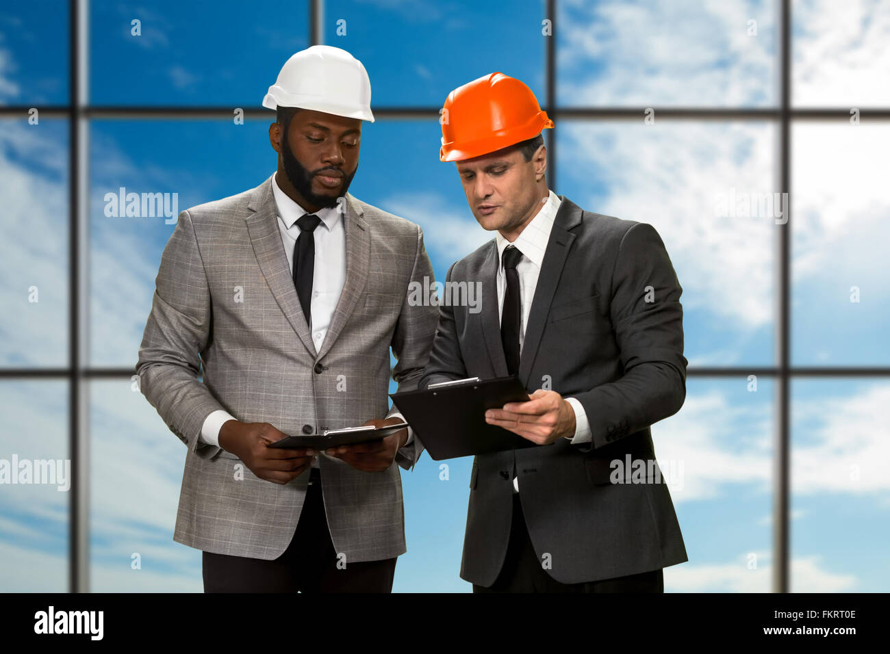 Two architects on sky background Stock Photo - Alamy