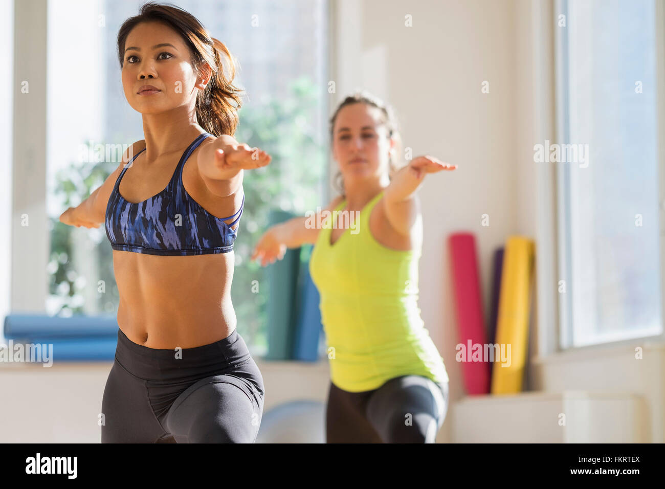 Women practicing yoga in studio Stock Photo - Alamy