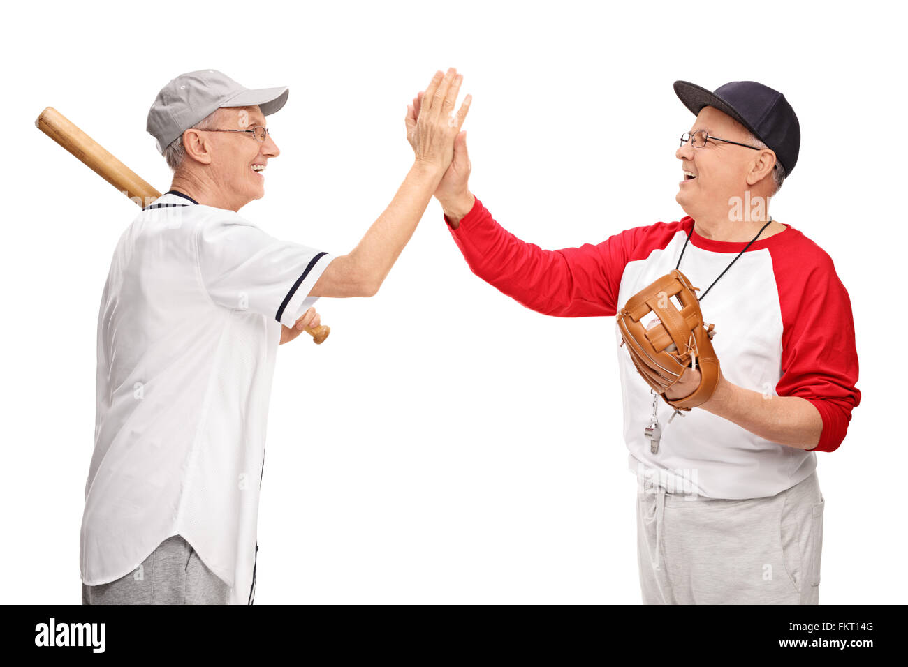 Studio shot of two senior men in baseball outfits high-five each other ...