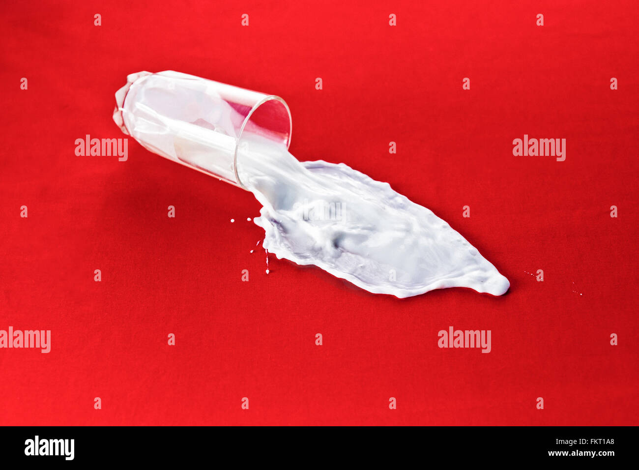 Glass with spilled milk Stock Photo - Alamy