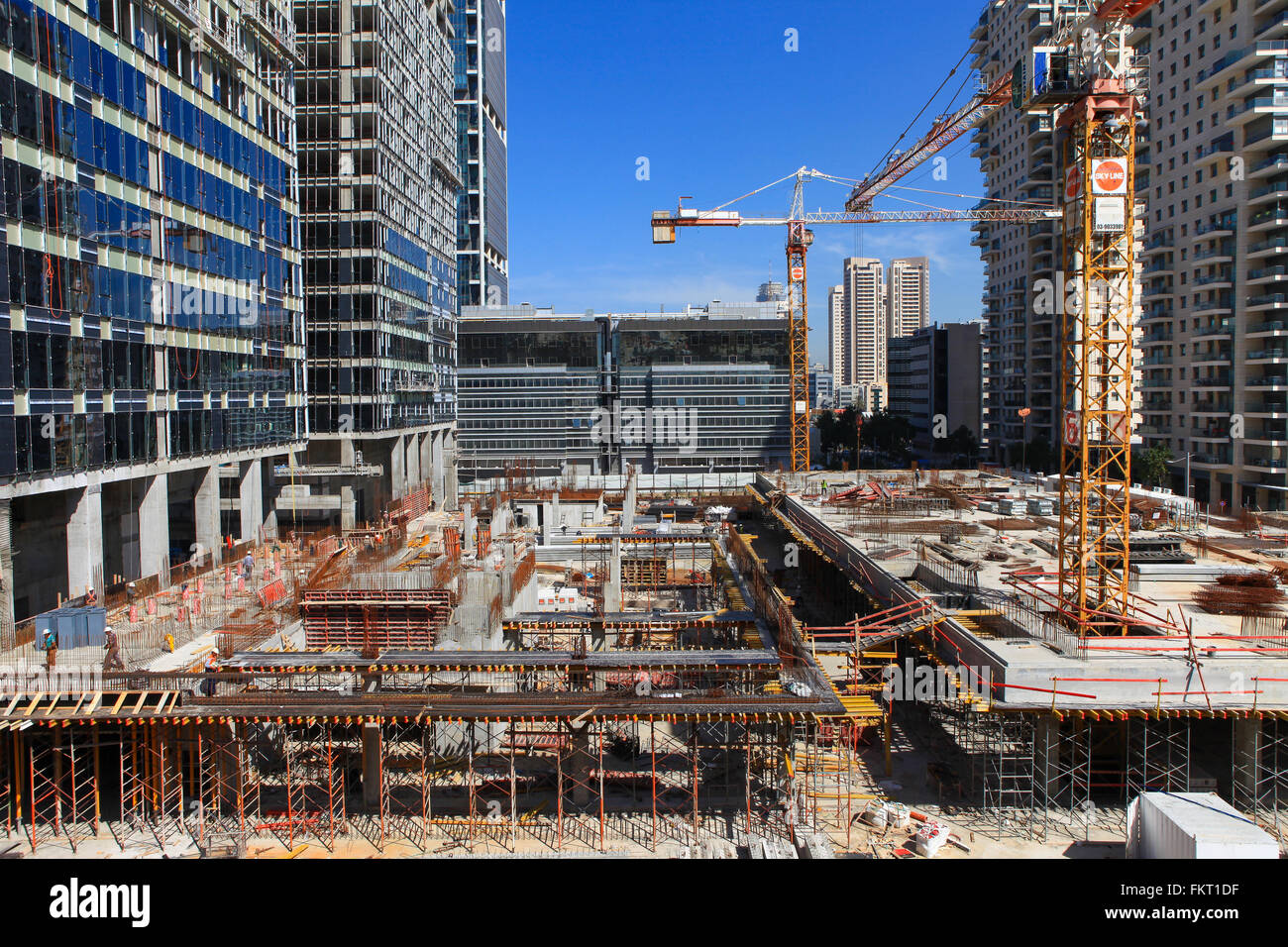 New skyscraper Construction site with workers at the business center of ...