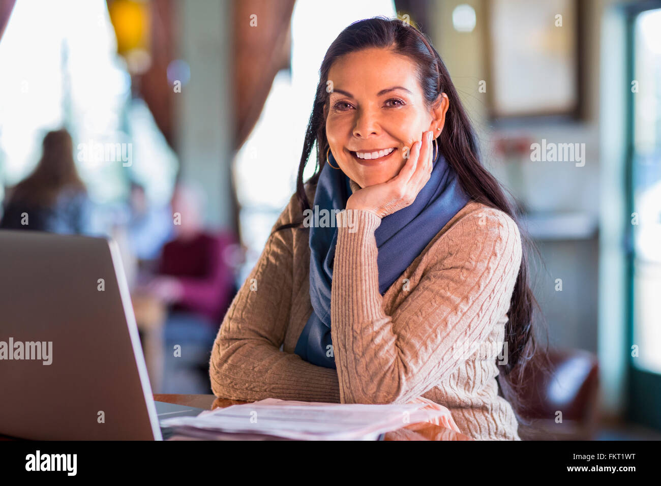 Hispanic woman using laptop in cafe Stock Photo - Alamy