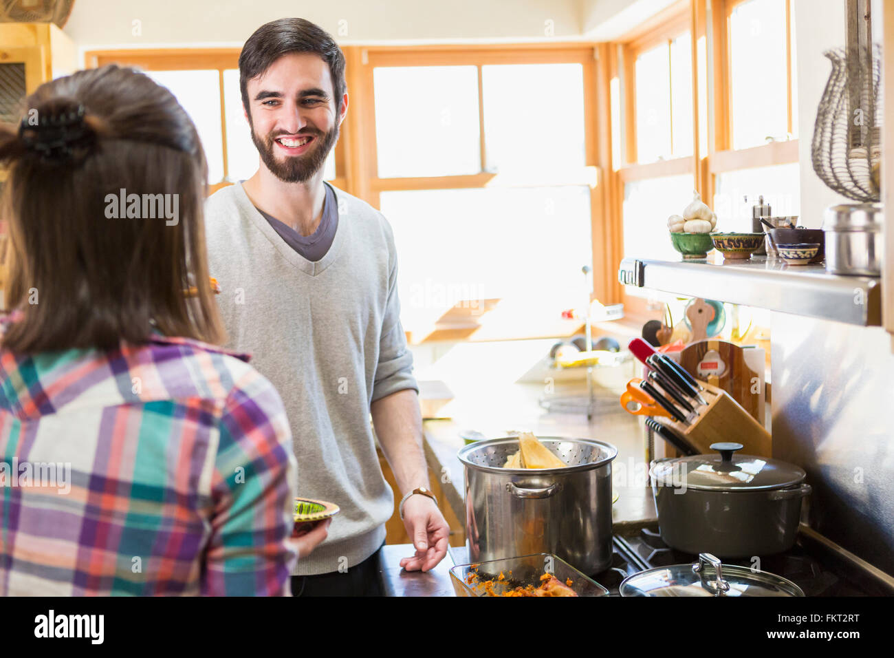 Hispanic couple cooking in kitchen Stock Photo - Alamy