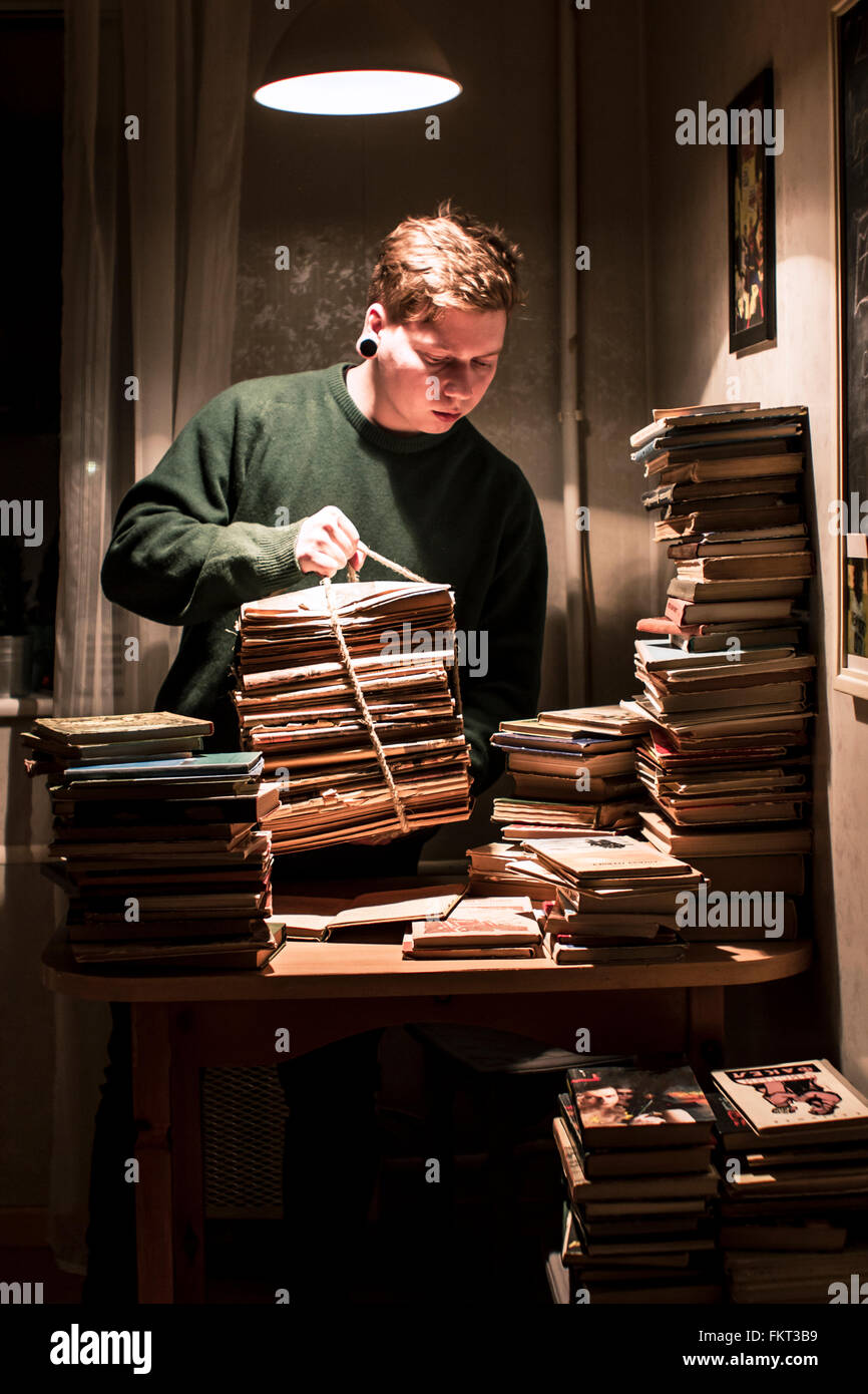 Man holding pile books hi-res stock photography and images - Alamy