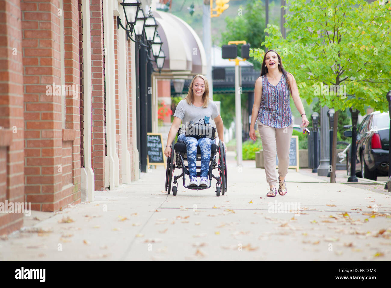 Women talking on sidewalk Stock Photo - Alamy