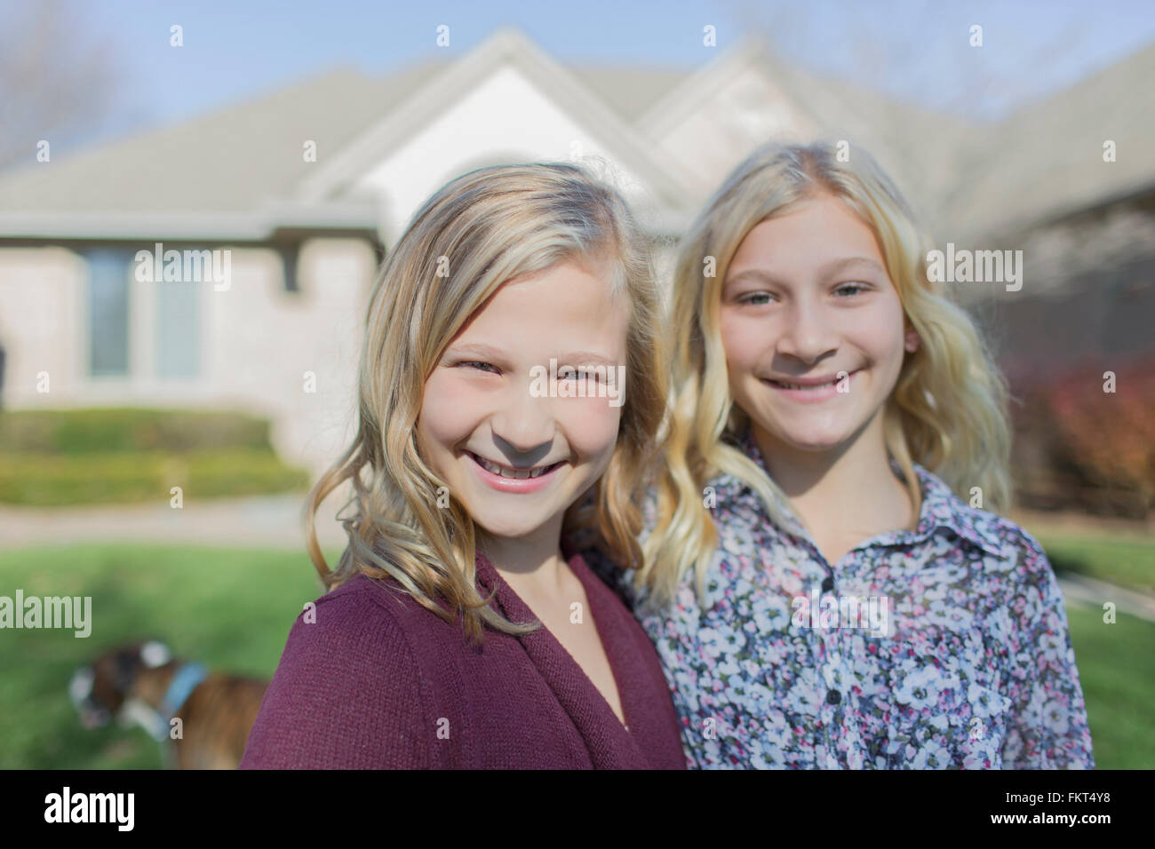 Caucasian girls smiling in yard Stock Photo - Alamy