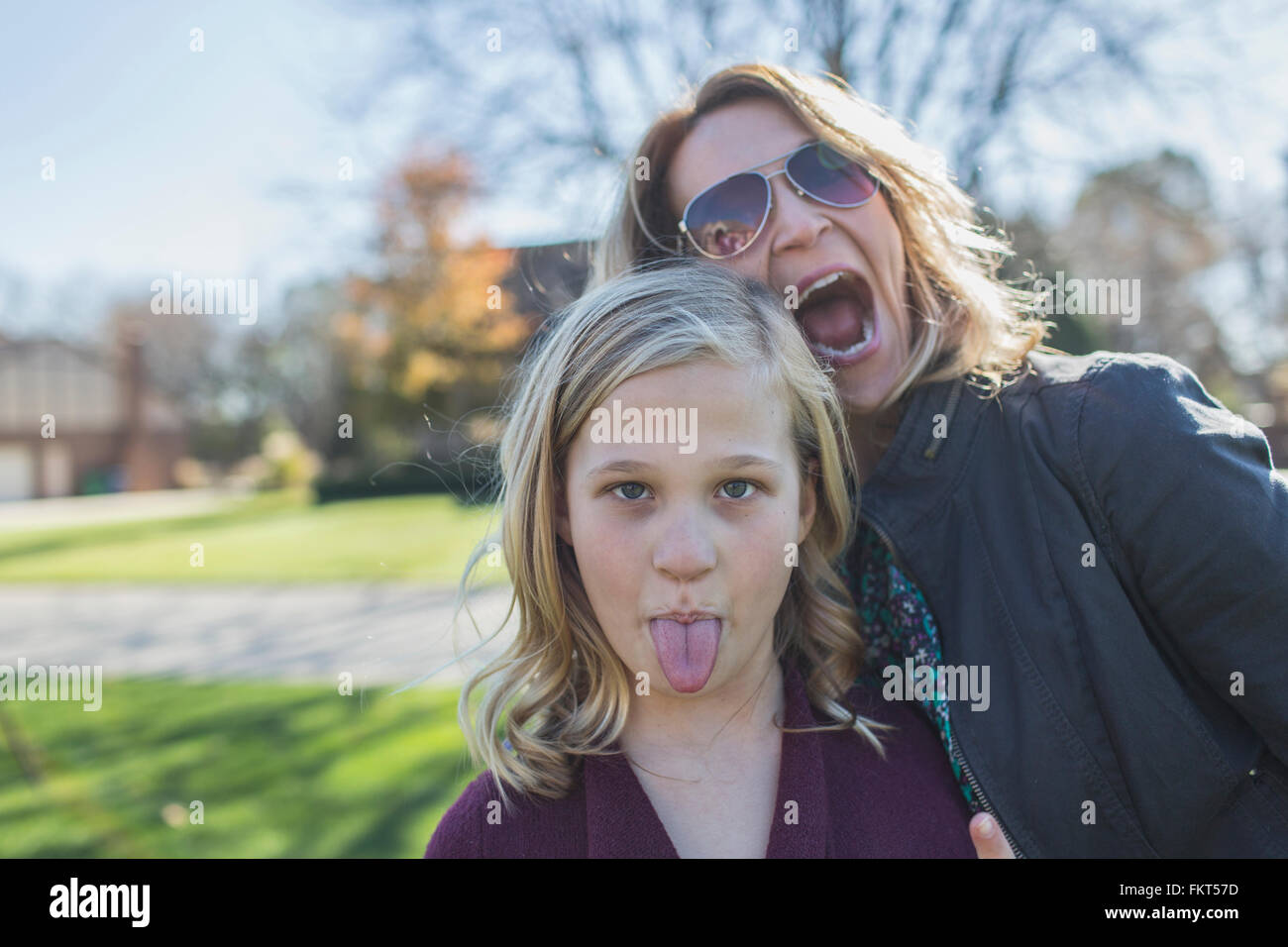 Caucasian mother and daughter making faces outdoors Stock Photo - Alamy