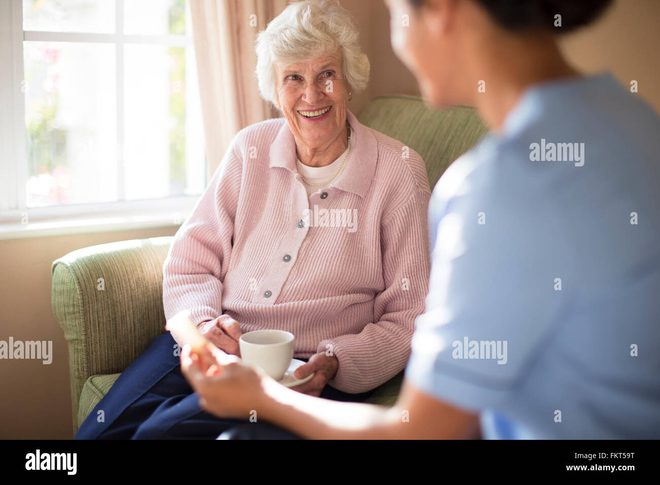 Smiling nurse holding tea hi-res stock photography and images - Alamy