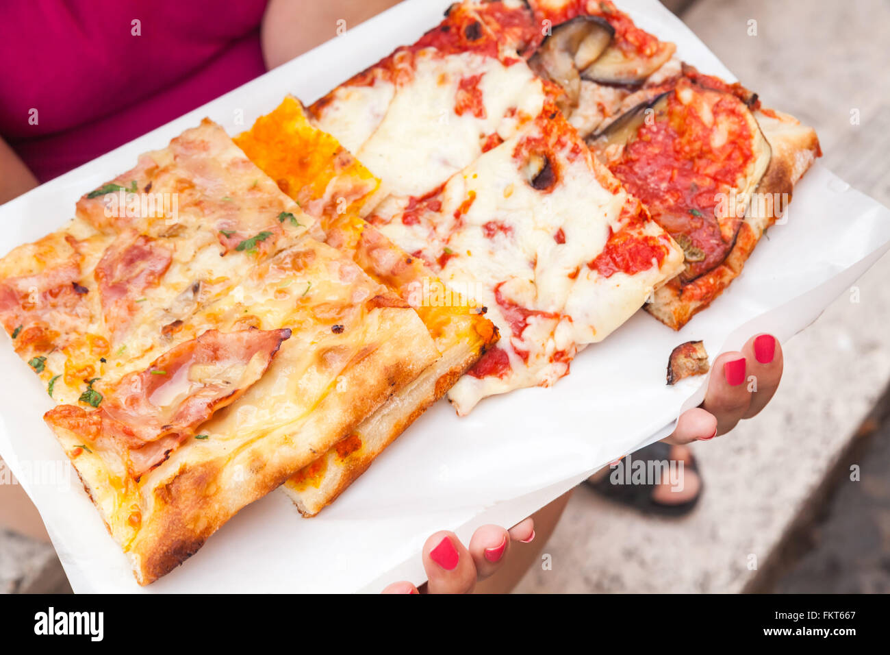Slices of fresh different Italian Pizza in woman hands Stock Photo - Alamy