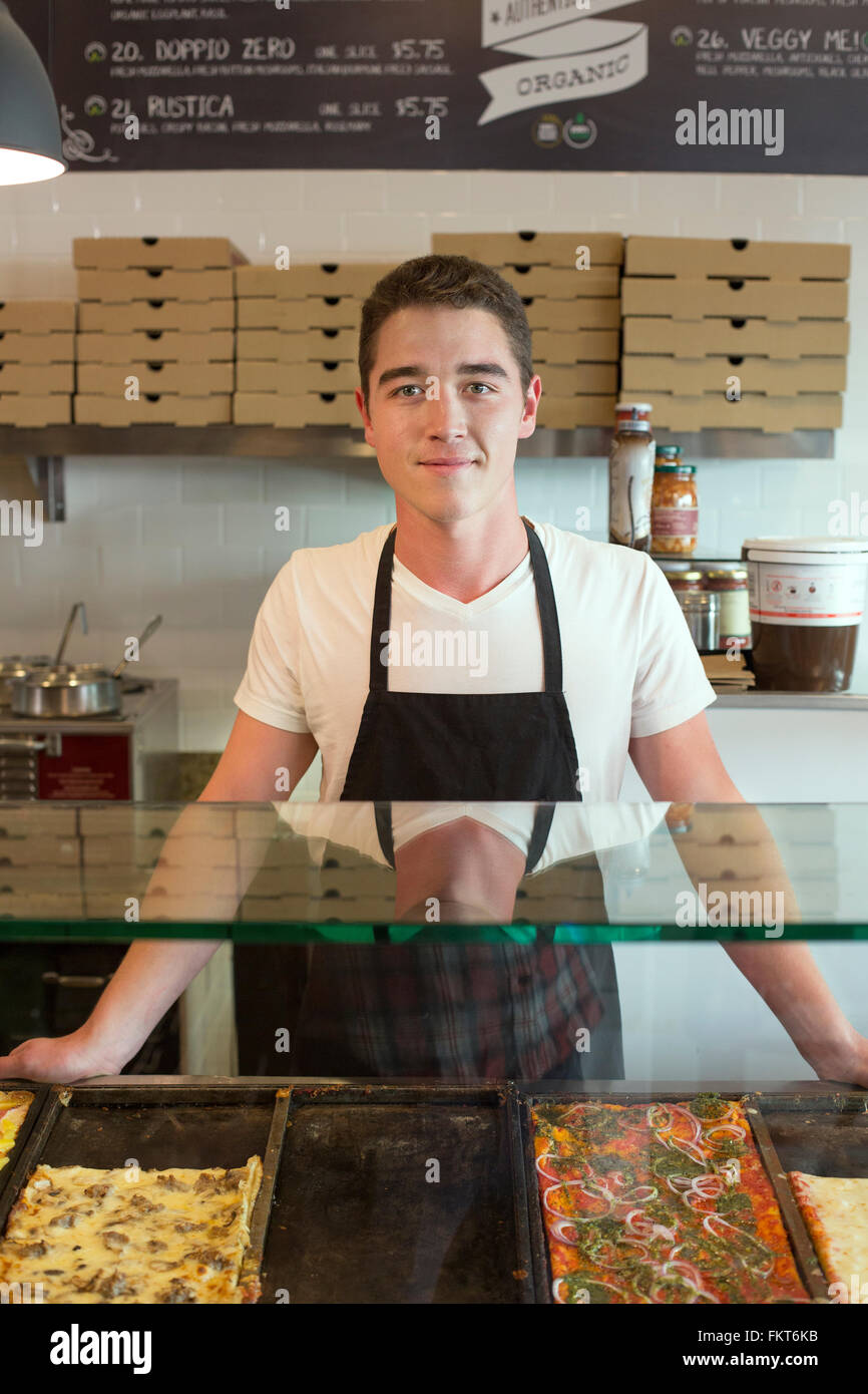 Server smiling in cafe Stock Photo - Alamy