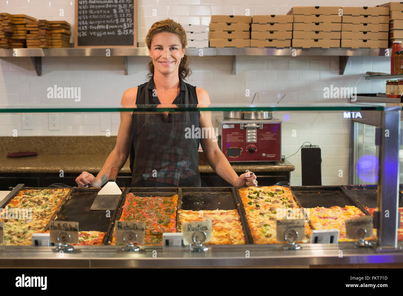 Caucasian server smiling in cafe Stock Photo - Alamy