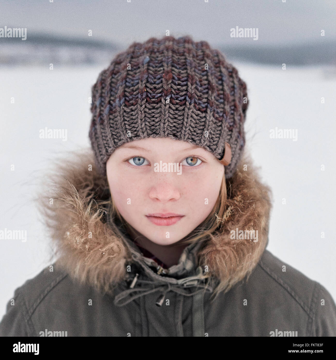Caucasian teenage girl wearing beanie hat in snow Stock Photo - Alamy