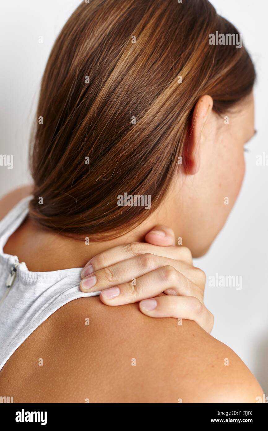 Woman massaging right shoulder Stock Photo - Alamy
