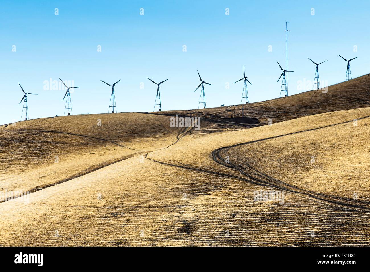 Low angle view of wind turbines on rolling landscape, California, USA ...