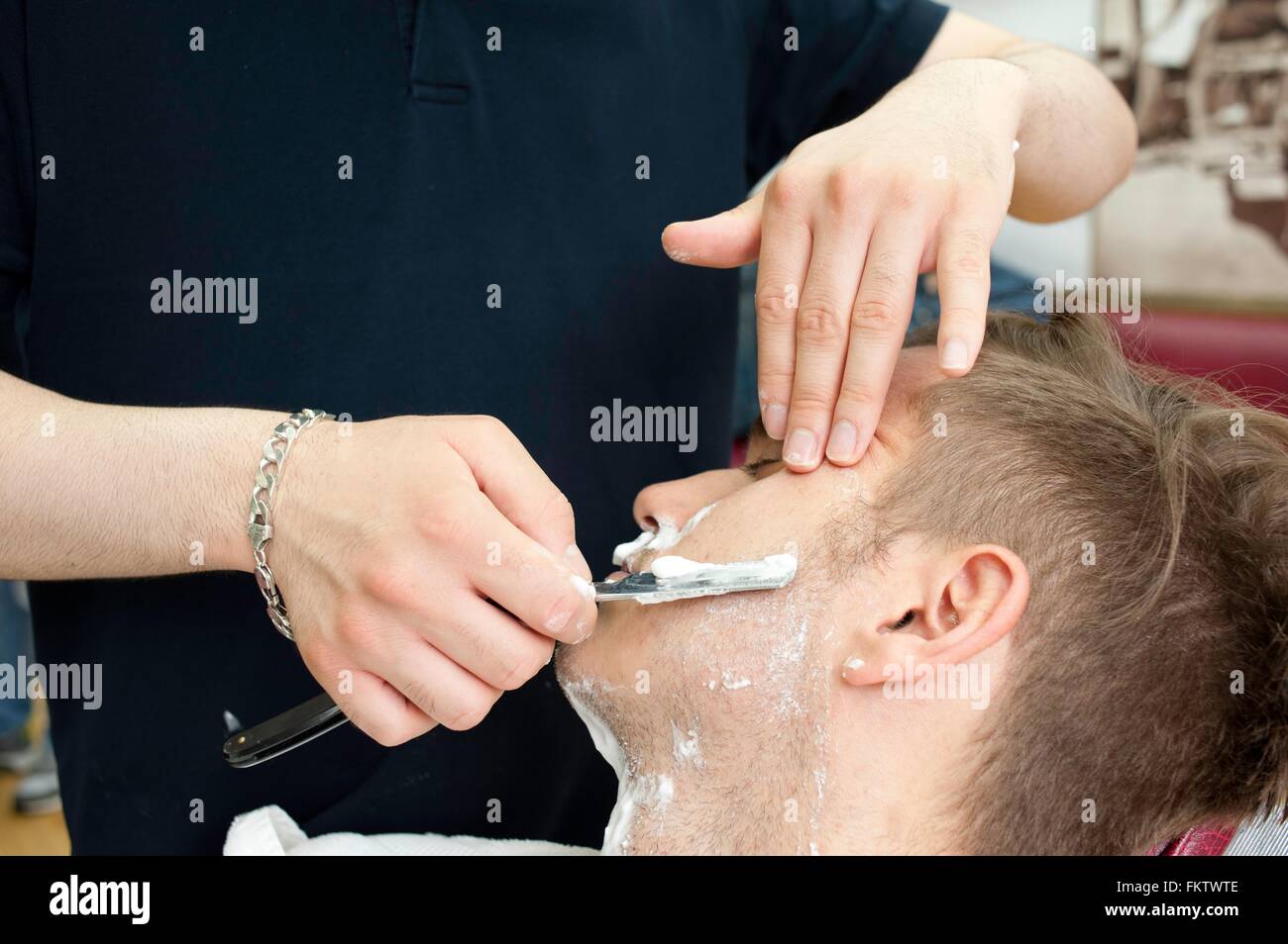 Barber shaving man in barbershop hi-res stock photography and images ...