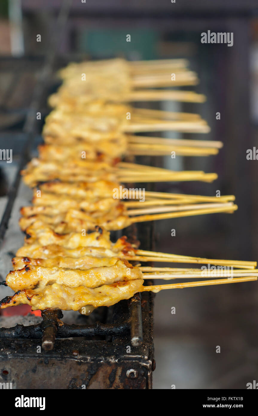 Pork satay grilled on stove Stock Photo - Alamy