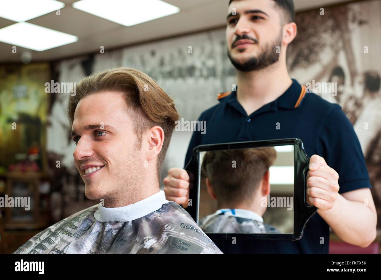 Barber using mirror to show smiling customer haircut Stock Photo - Alamy Barber using mirror to show smiling customer haircut Stock Photo - Alamy