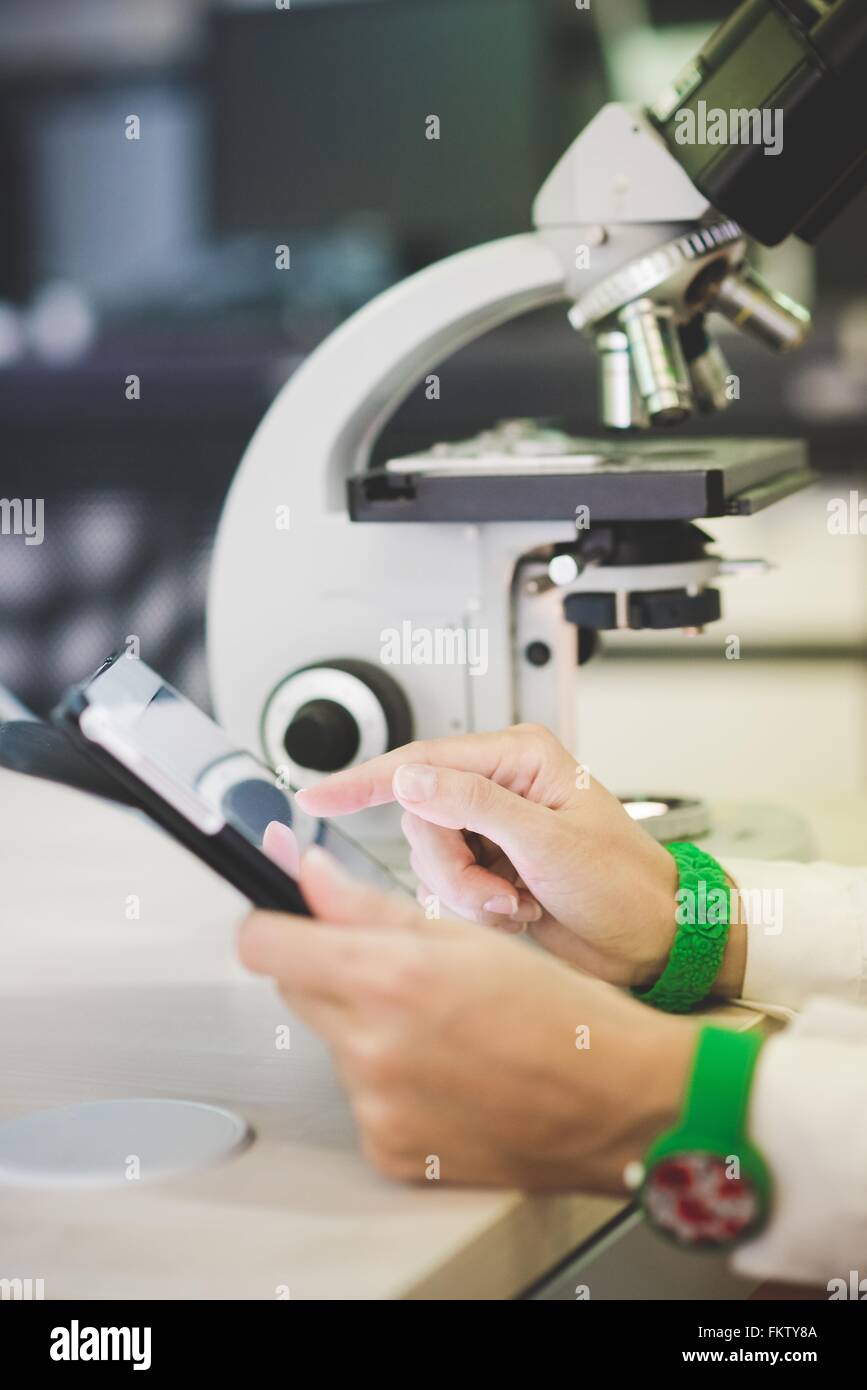 Scientist using digital tablet and optical microscope Stock Photo - Alamy Scientist using digital tablet and optical microscope Stock Photo - Alamy