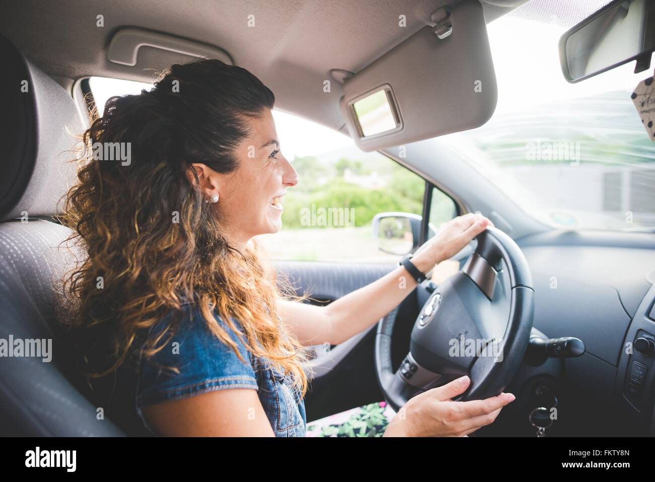 Happy woman driving a car Stock Photo - Alamy
