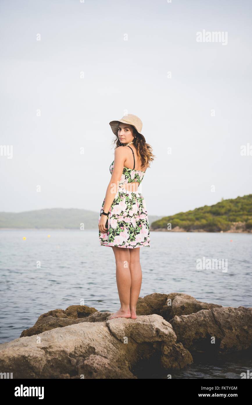 Woman standing on rocks hi-res stock photography and images - Alamy
