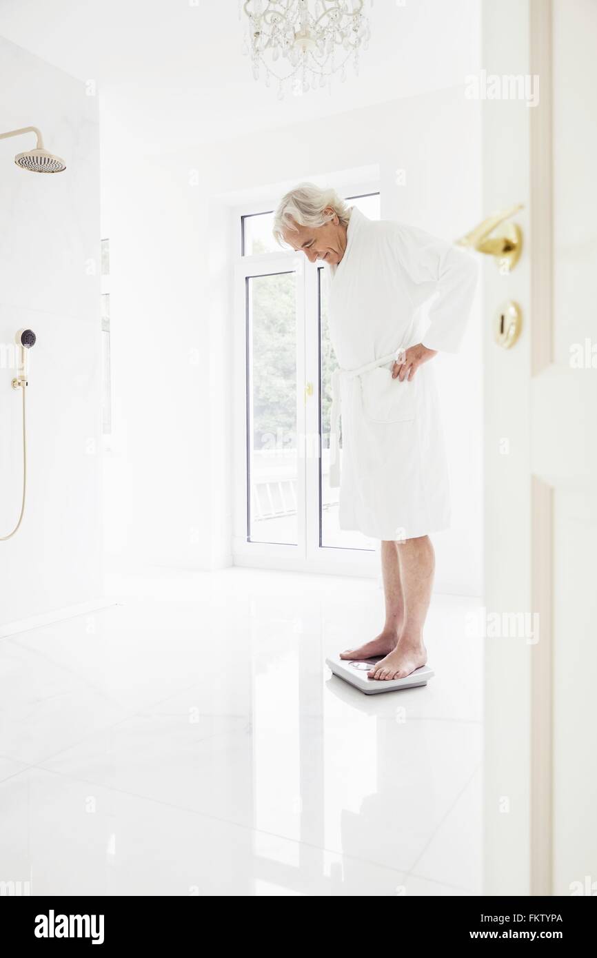 Man weighing himself on the scales hi-res stock photography and images ...