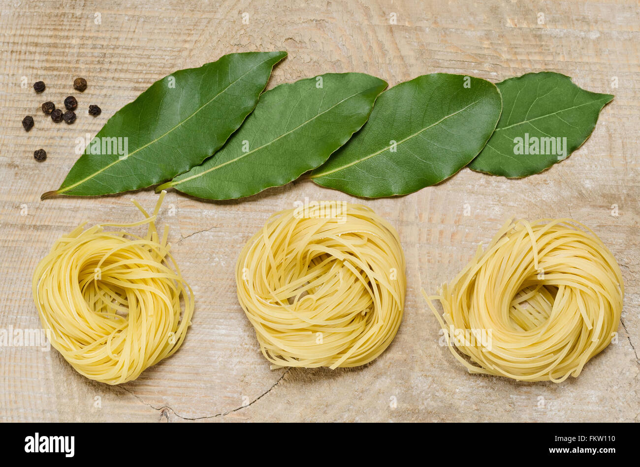 Not cooked pasta and spices lying on the old Board Stock Photo - Alamy