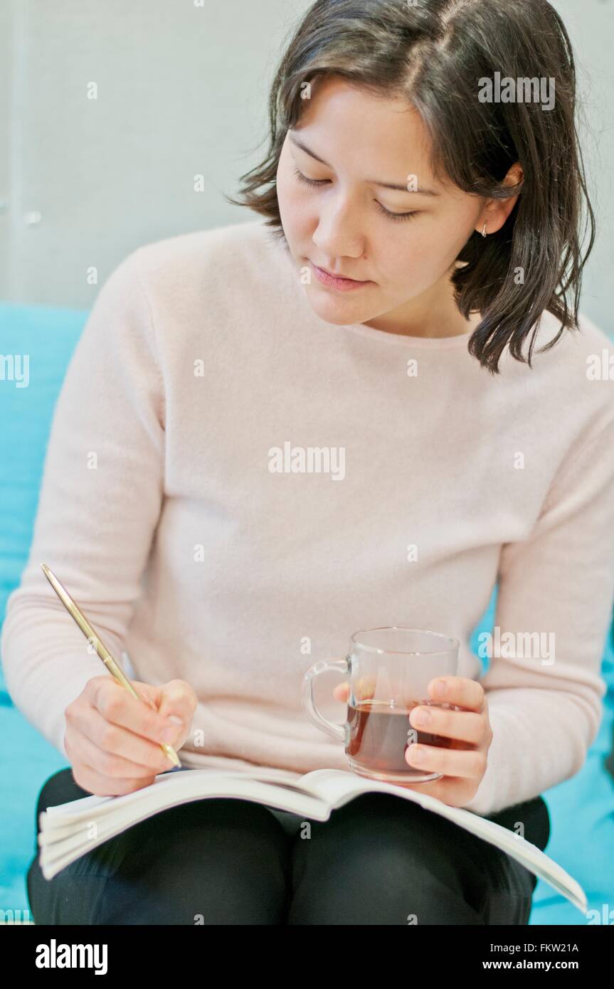 Woman writing notes Stock Photo - Alamy