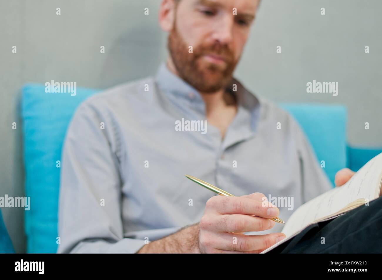 Man writing notes Stock Photo - Alamy
