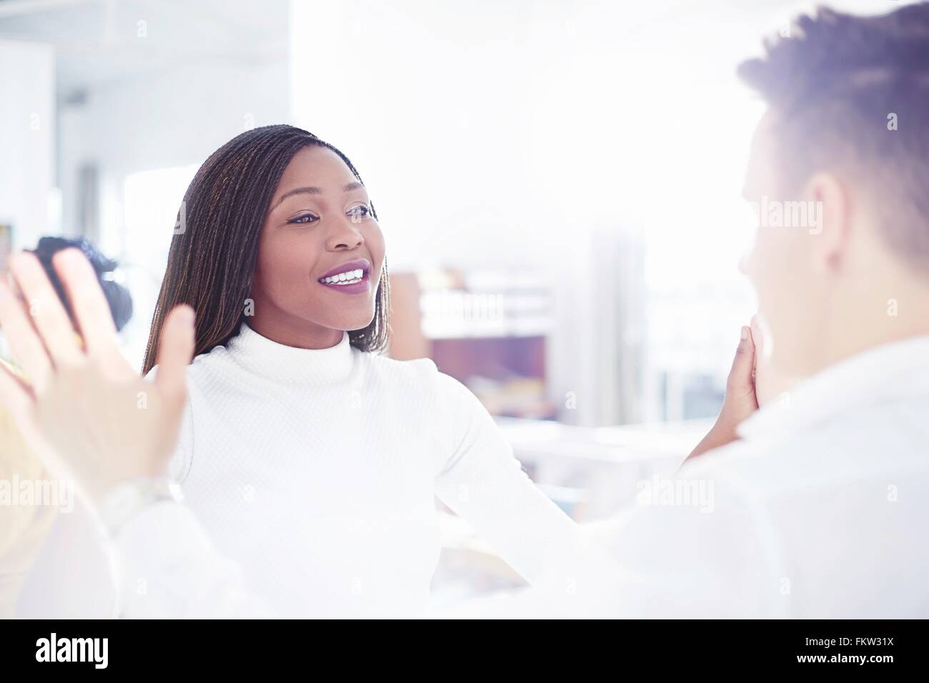 Over the shoulder view couple face to face hands together smiling Stock ...