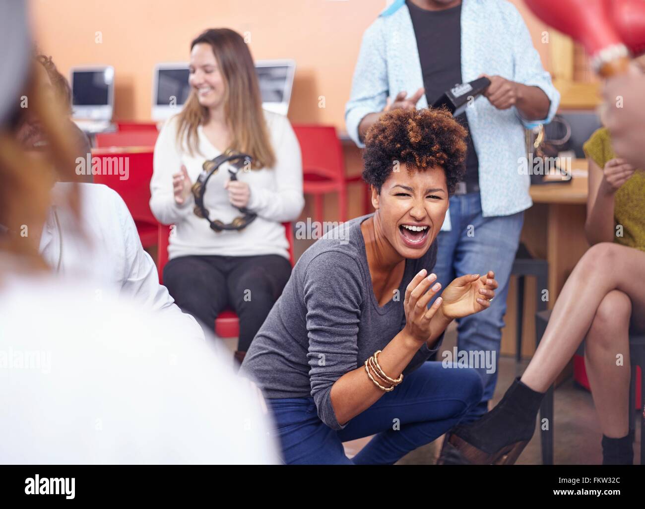 Friends playing musical instruments and dancing, smiling Stock Photo ...