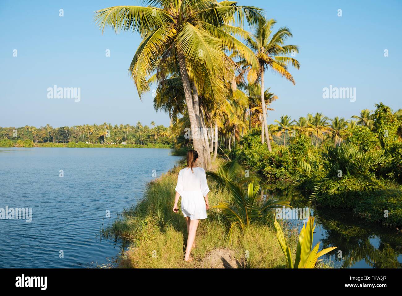 Young woman walking at Kerala Backwaters near North Paravoor, Kerala ...