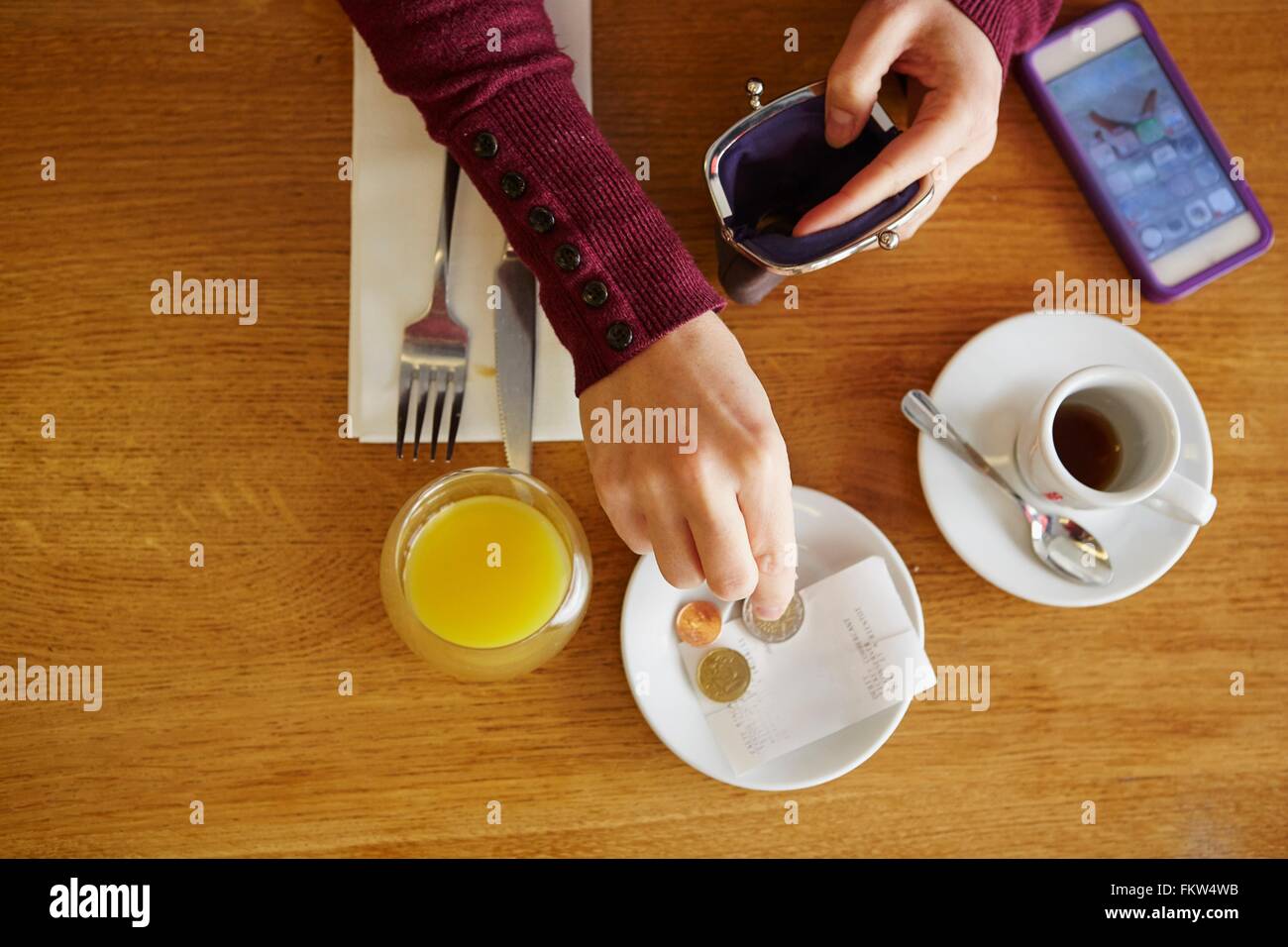 Overhead cropped view of woman leaving gratuity in restaurant Stock ...