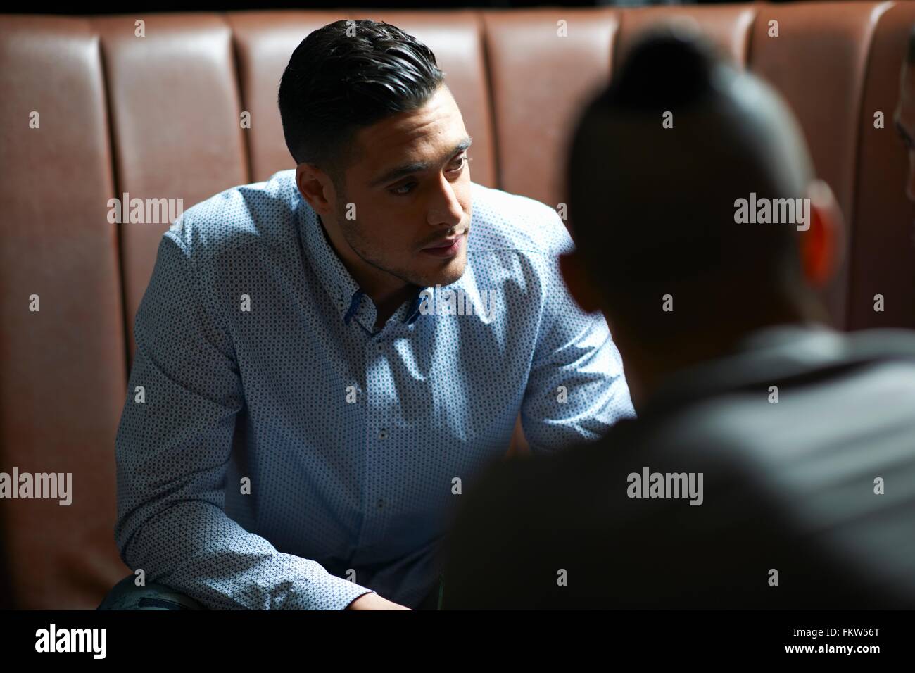 Male friends having discussion in traditional UK pub Stock Photo - Alamy
