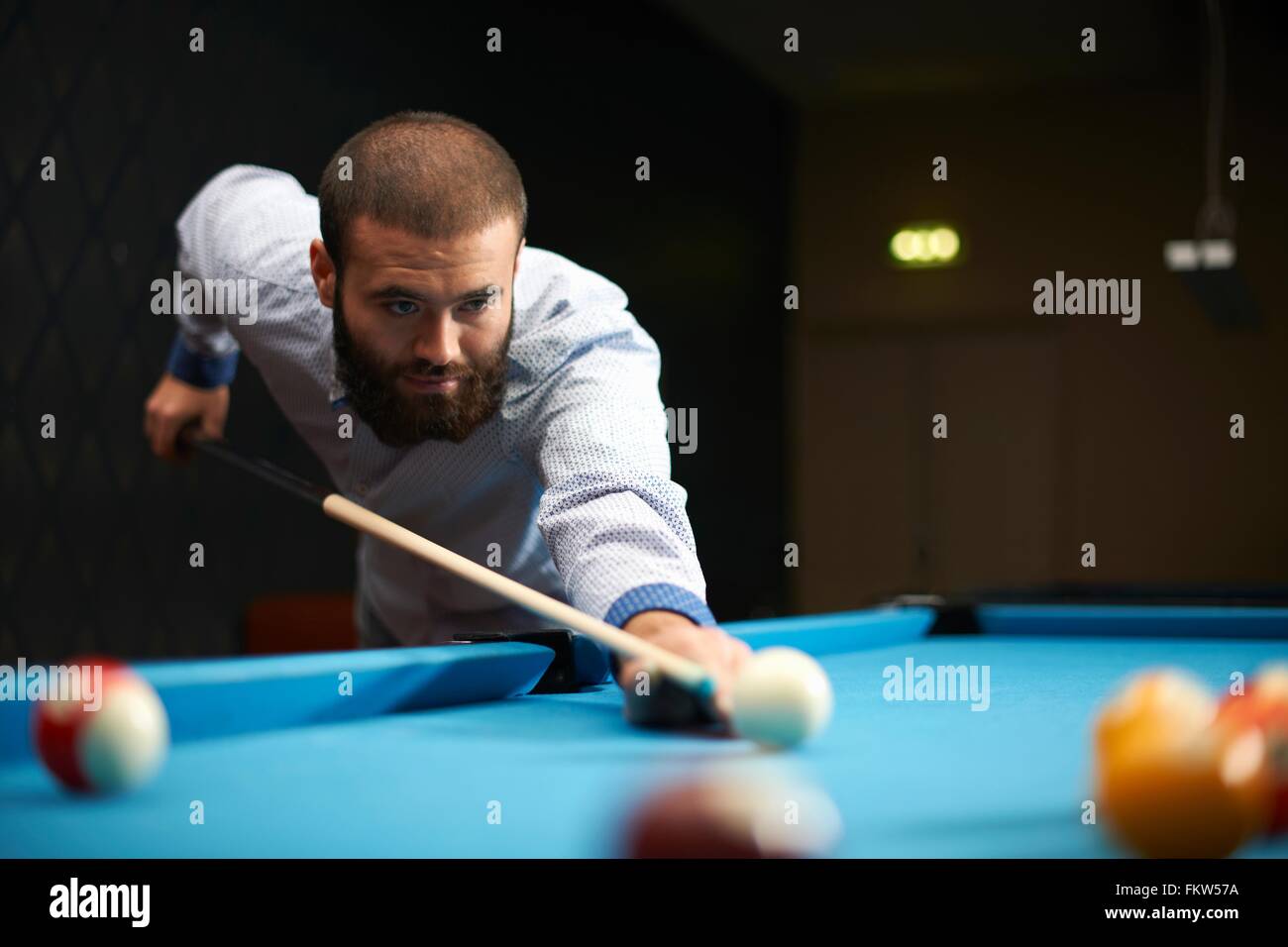 Man playing pool in club Stock Photo - Alamy