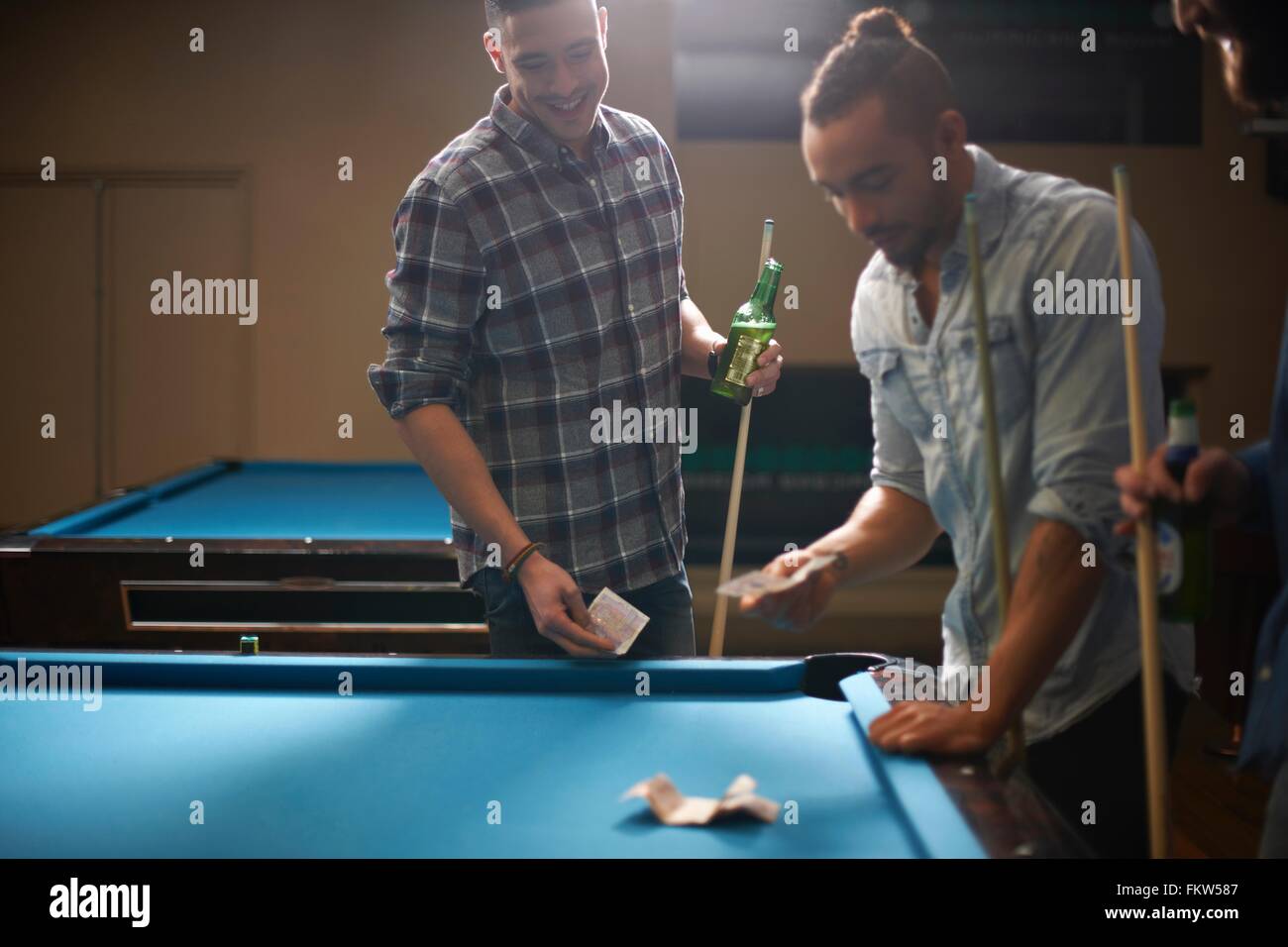 Young man standing at pool table hi-res stock photography and images ...